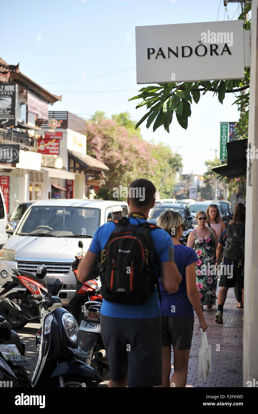 tourist walking at side walk of the street, windows shopping at Monkey ...