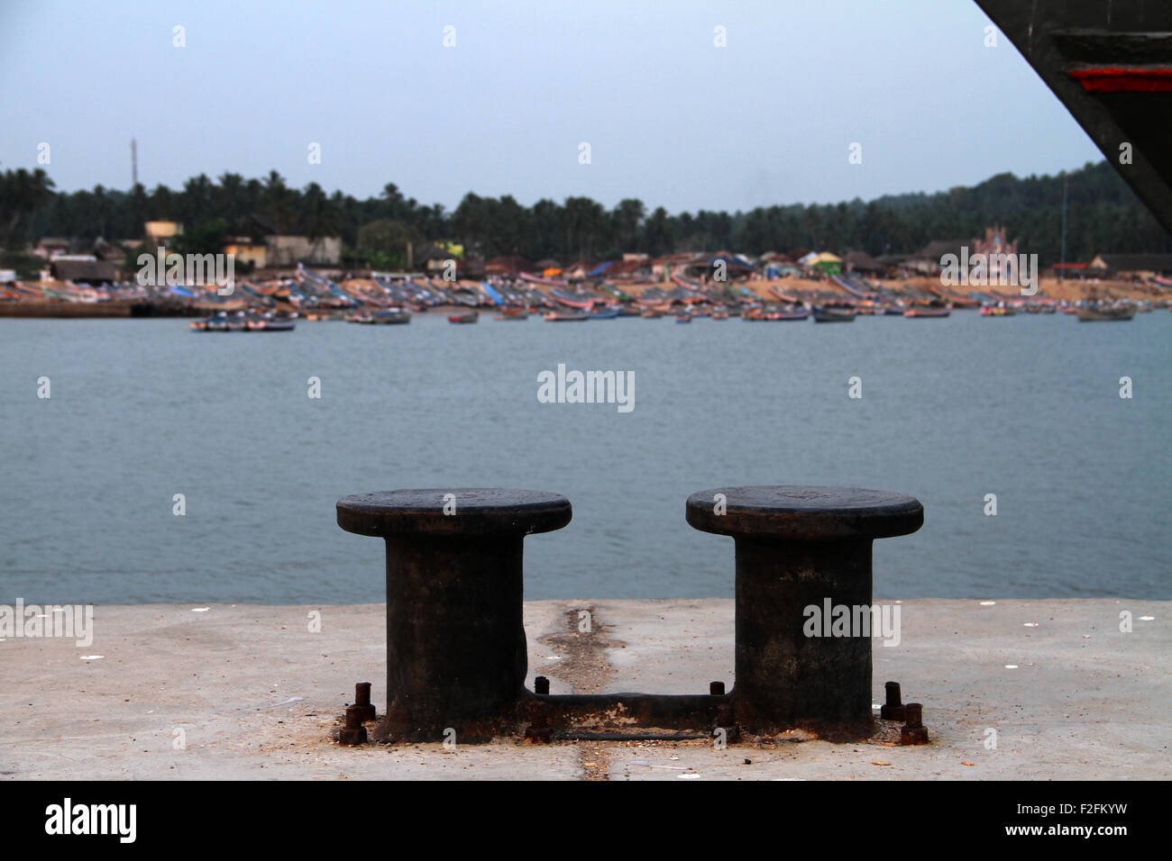 Ship docked with rusty boat anchor chain and shackle with thick rope ...