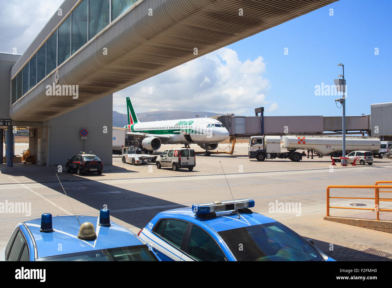 View of police cars and airplane in the airport Stock Photo - Alamy