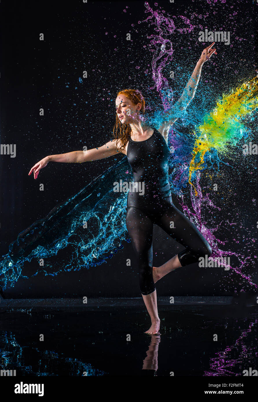 Female Dancer Being Splashed with Colorful Water Stock Photo - Alamy