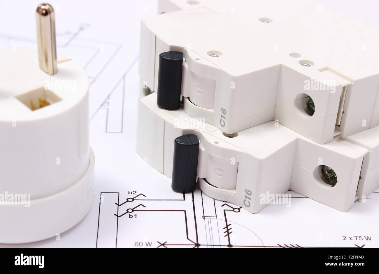 Electric plug and fuse lying on construction drawing of house ...