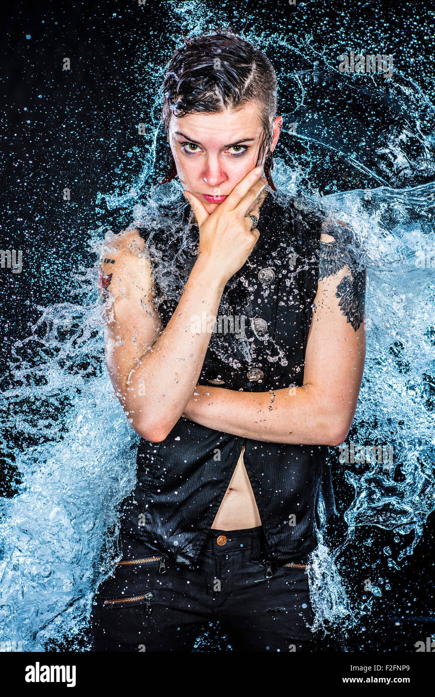 Boyish Woman Looking Fierce in Water Splashes Stock Photo - Alamy