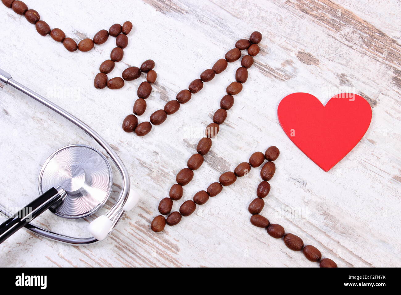 Electrocardiogram line of roasted coffee grains and medical stethoscope ...