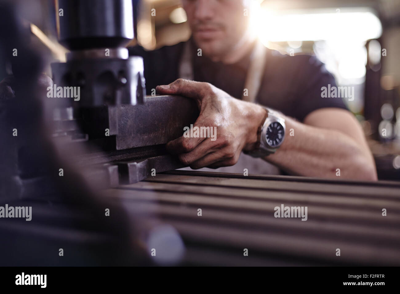 Close up mechanic using machinery in auto repair shop Stock Photo - Alamy