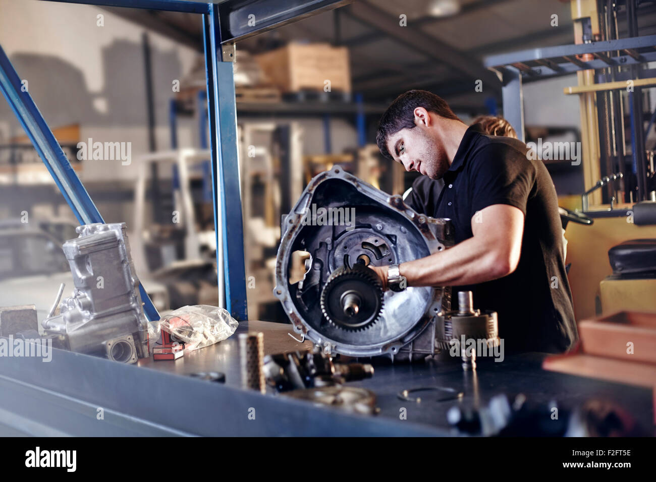 Mechanic fixing part in auto repair shop Stock Photo - Alamy