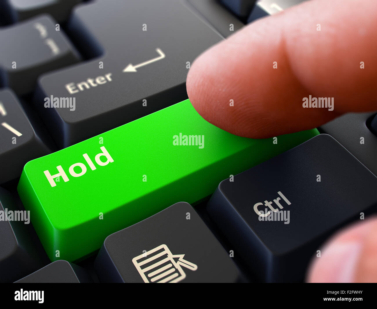 Finger Presses Green Button Hold on Black Keyboard Background. Closeup ...