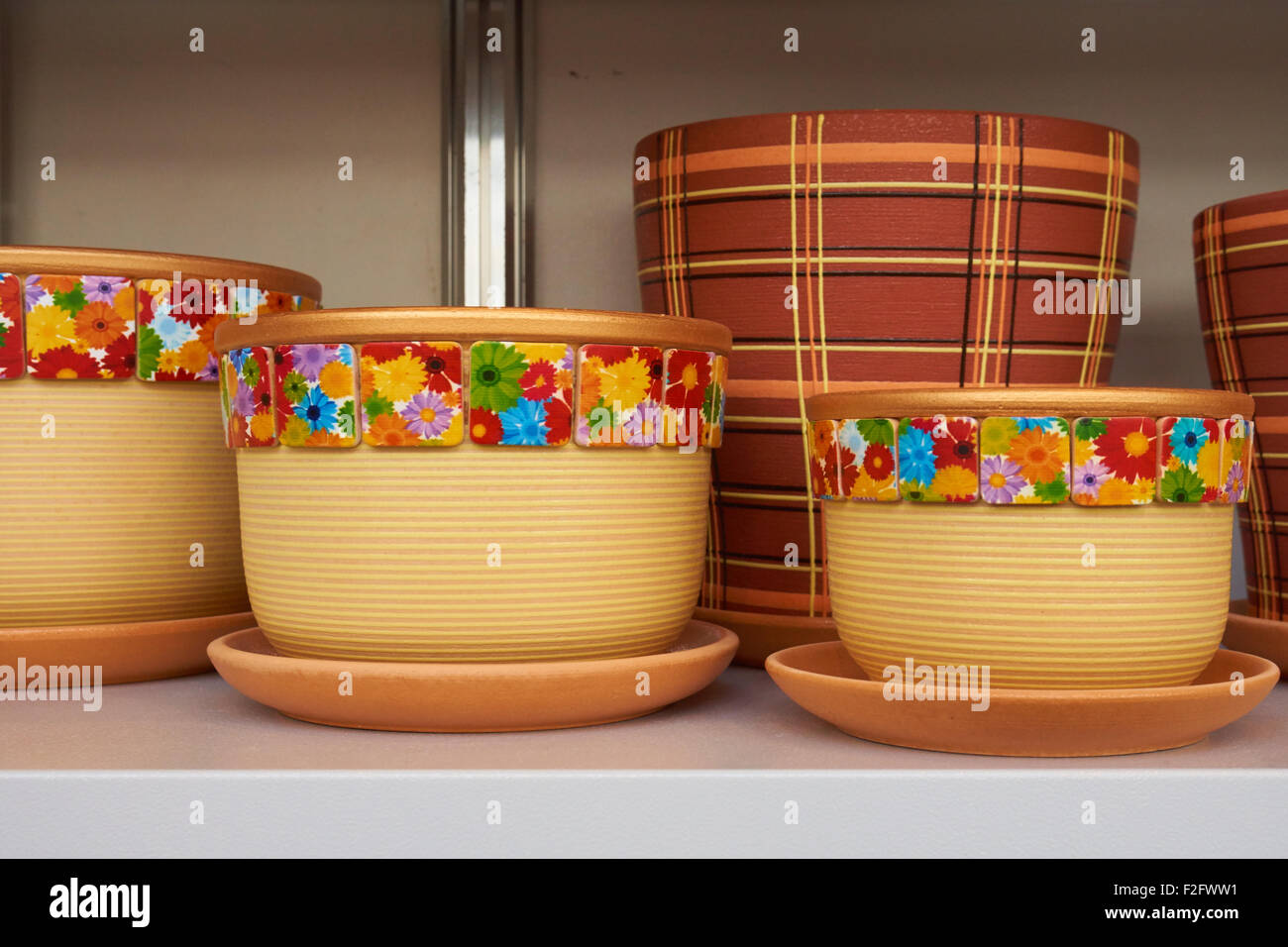 New ceramic beautiful flower pots on the the shelf Stock Photo - Alamy