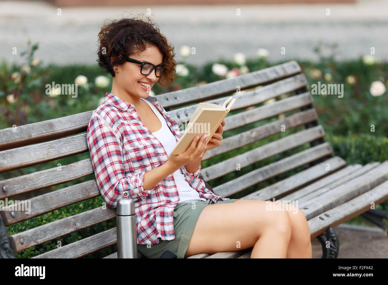 Nice girl sitting on the bench Stock Photo - Alamy