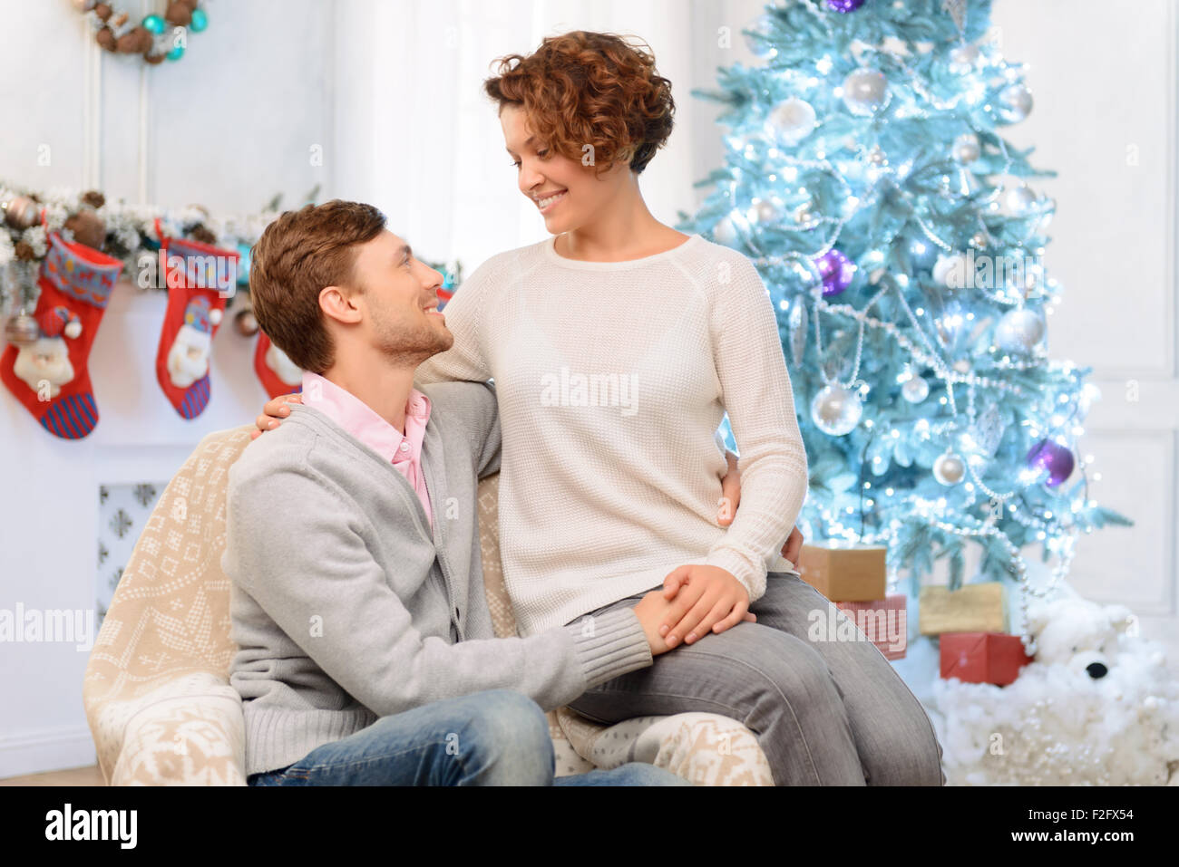 Loving couple sitting in the arm chair Stock Photo - Alamy