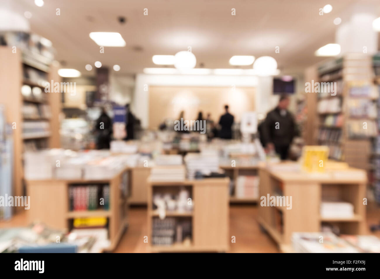 Out of focus shot from inside a bookstore, customers browsing the ...