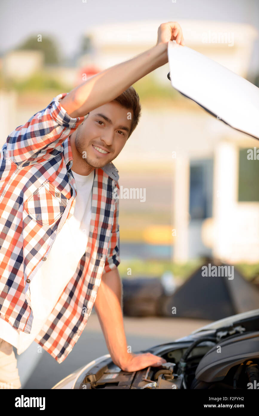 Nice boy opening bonnet Stock Photo - Alamy