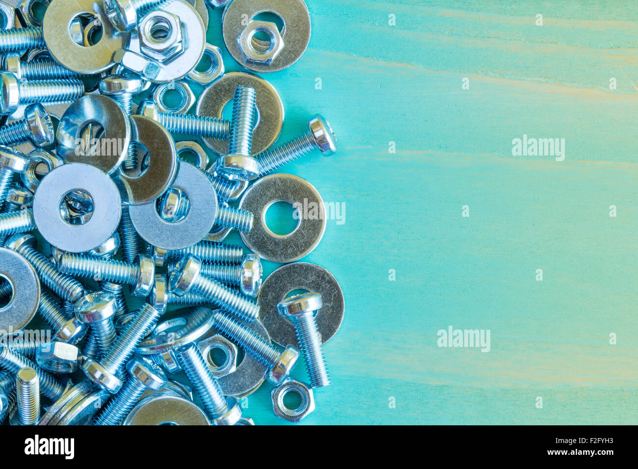 Bolts and nuts on wooden background with copy-space Stock Photo - Alamy