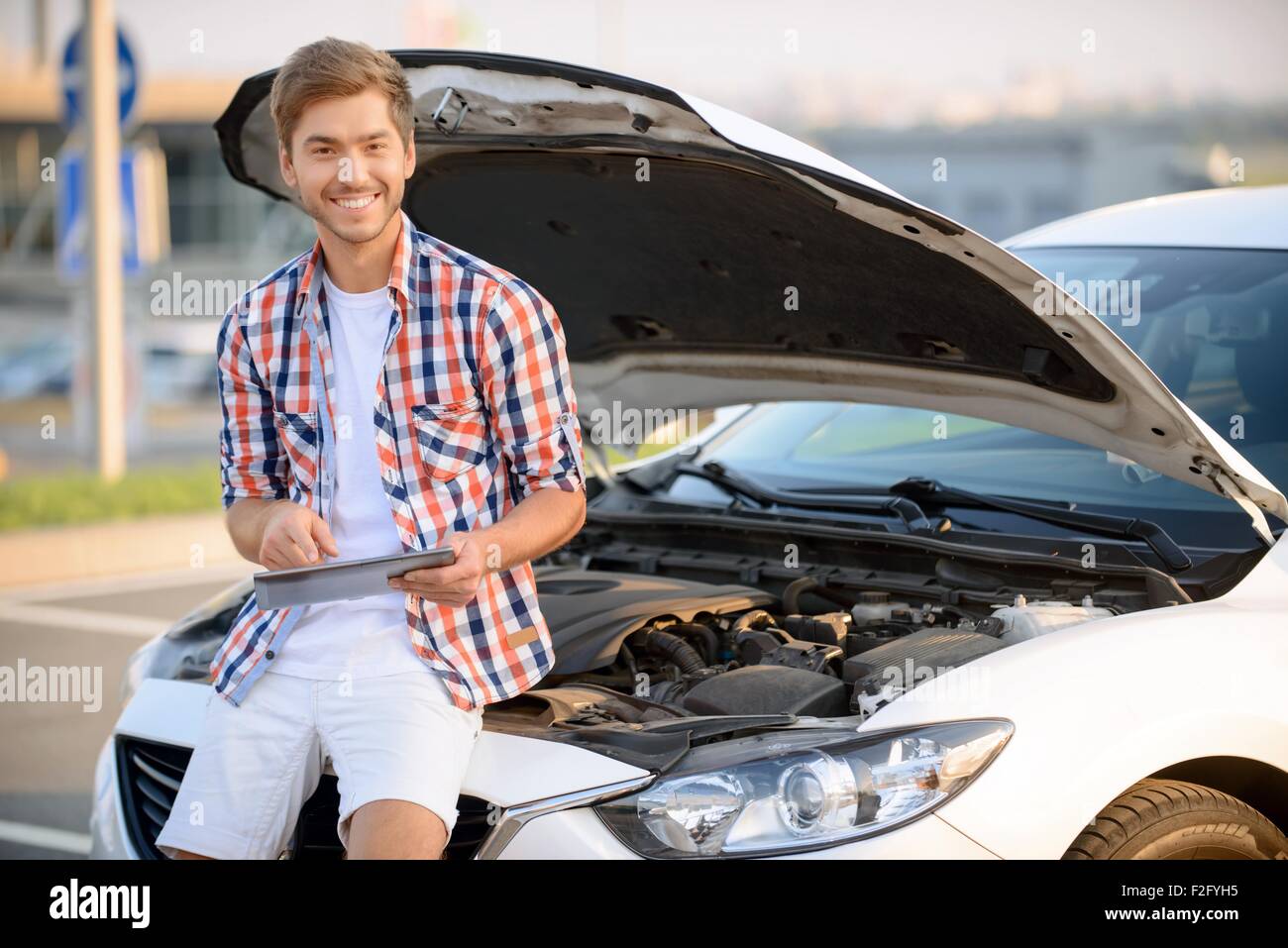 Nice boy opening bonnet Stock Photo - Alamy