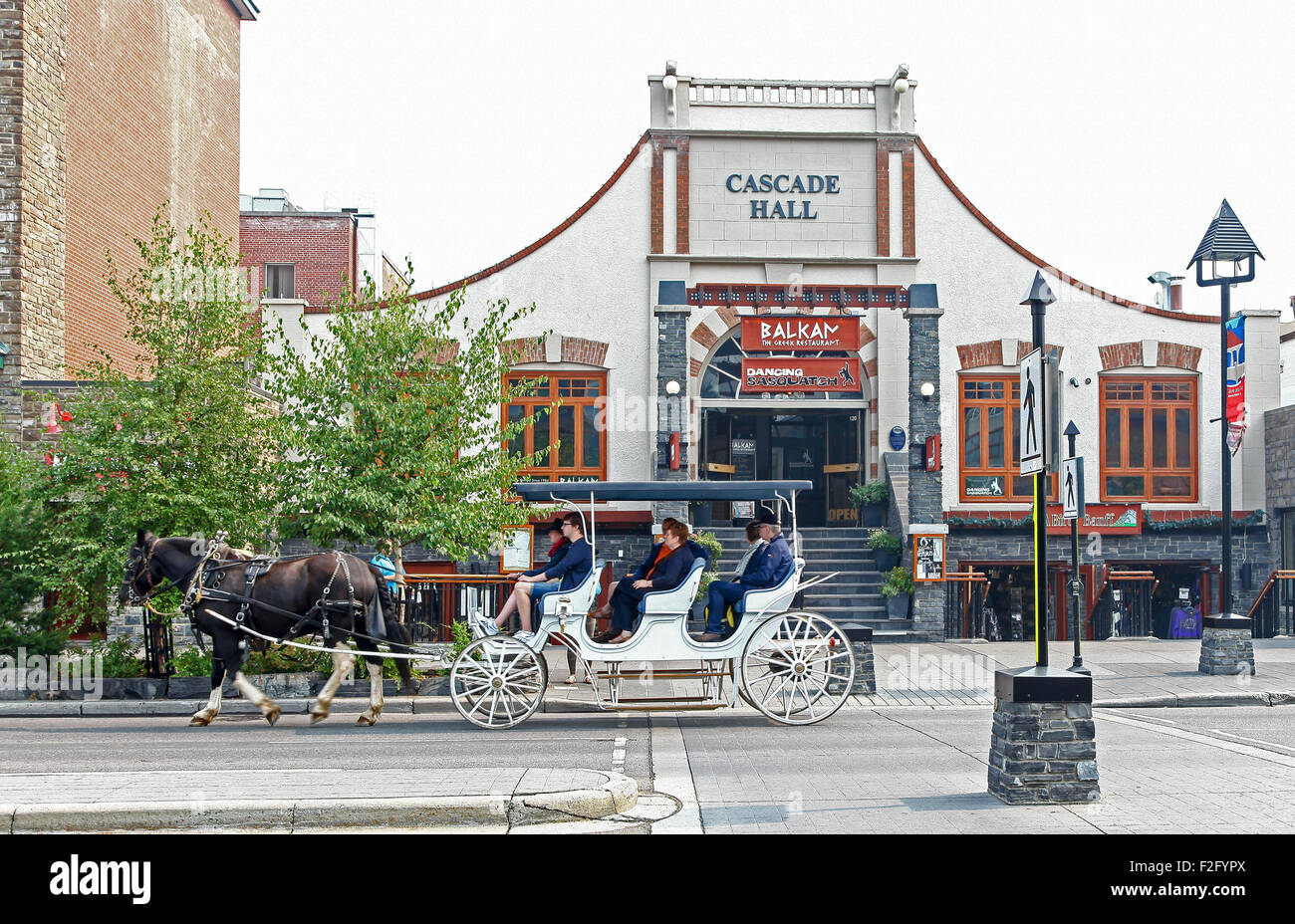 A horse-drawn carriage tour outside the Cascade Hall on Banff Avenue ...