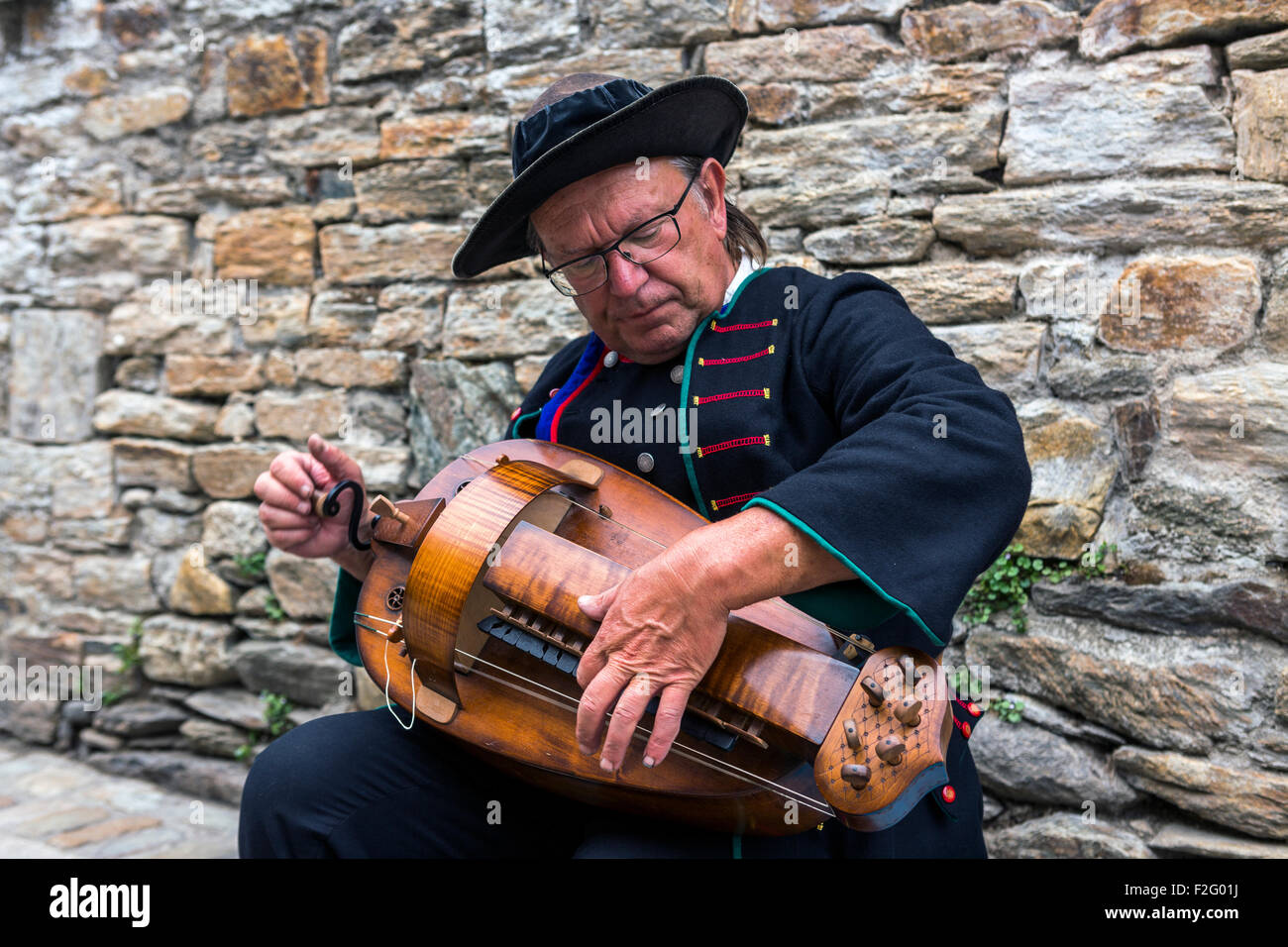 Man playing a traditional musical instrument among the streets of the ...