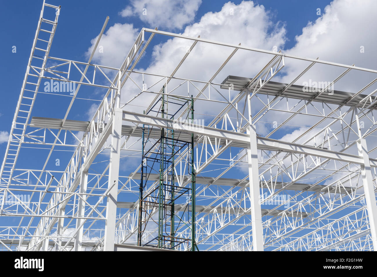 Construction of steel frame of big building with blue sky background ...
