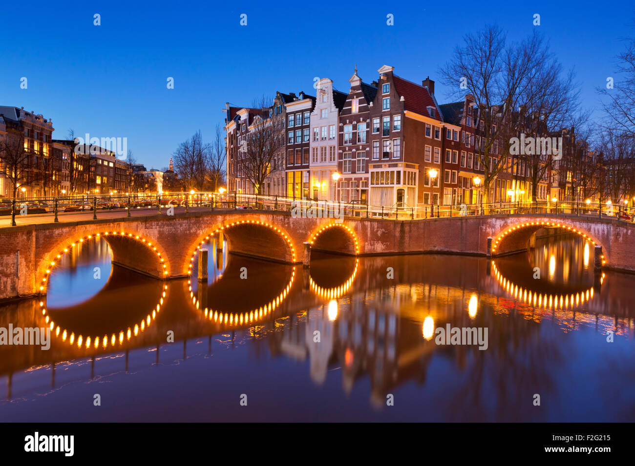 Bridges over a crossroads of canals in the city of Amsterdam, The ...