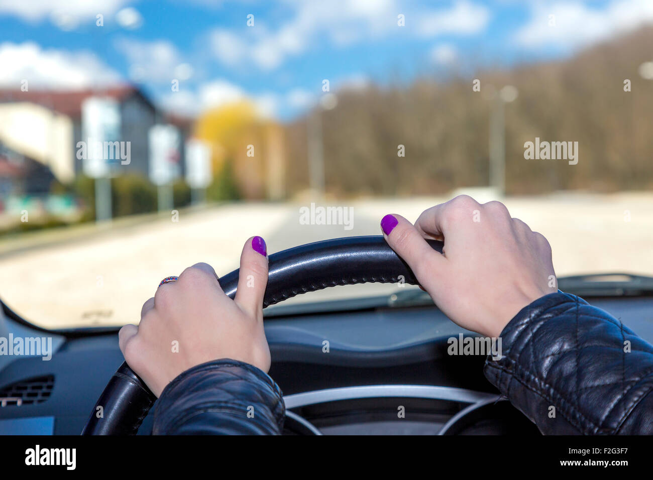 Hands of female driver on steering wheel Stock Photo - Alamy