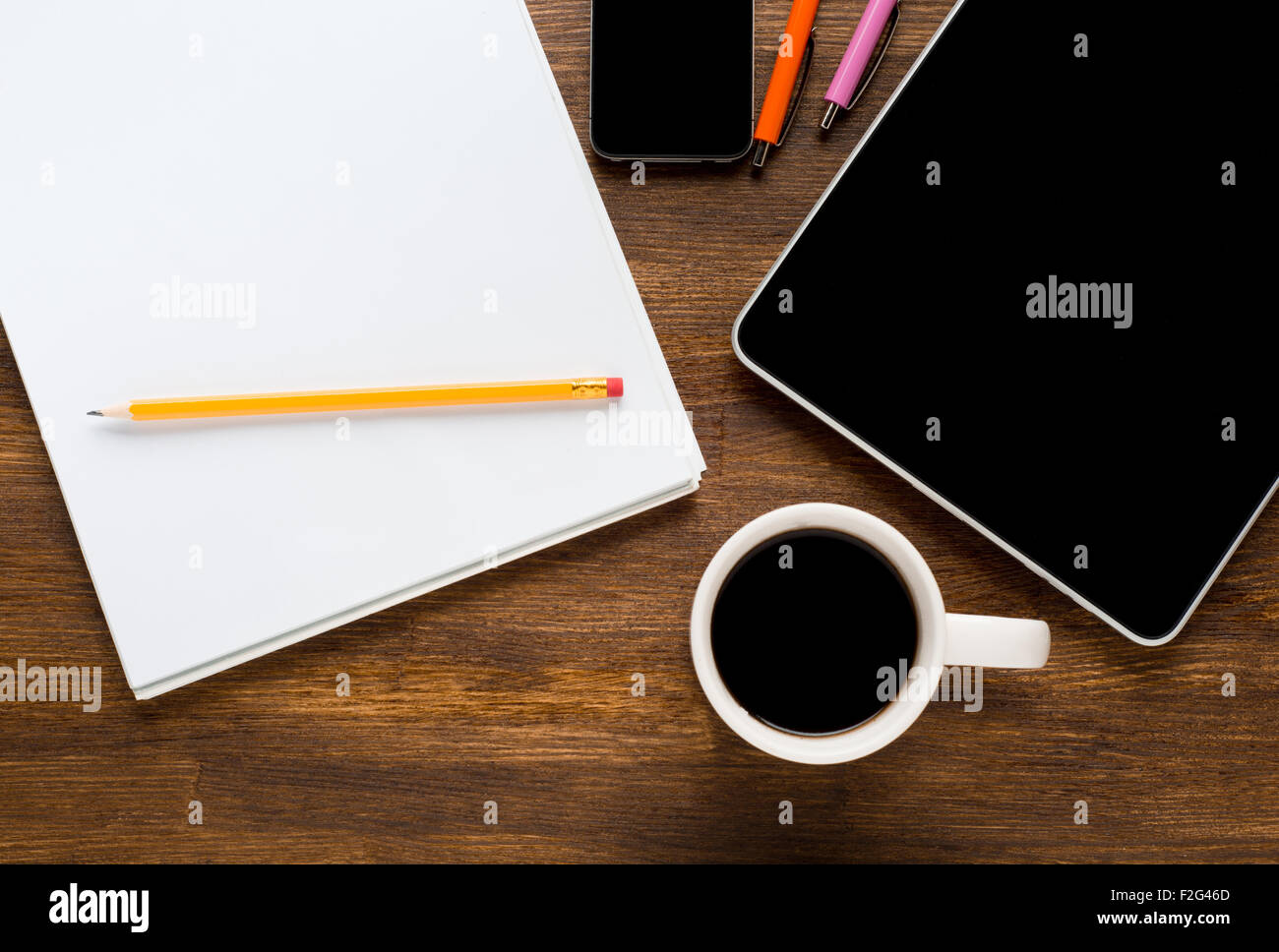 Tablet computer with stickers,cup of coffee and on the wooden table ...