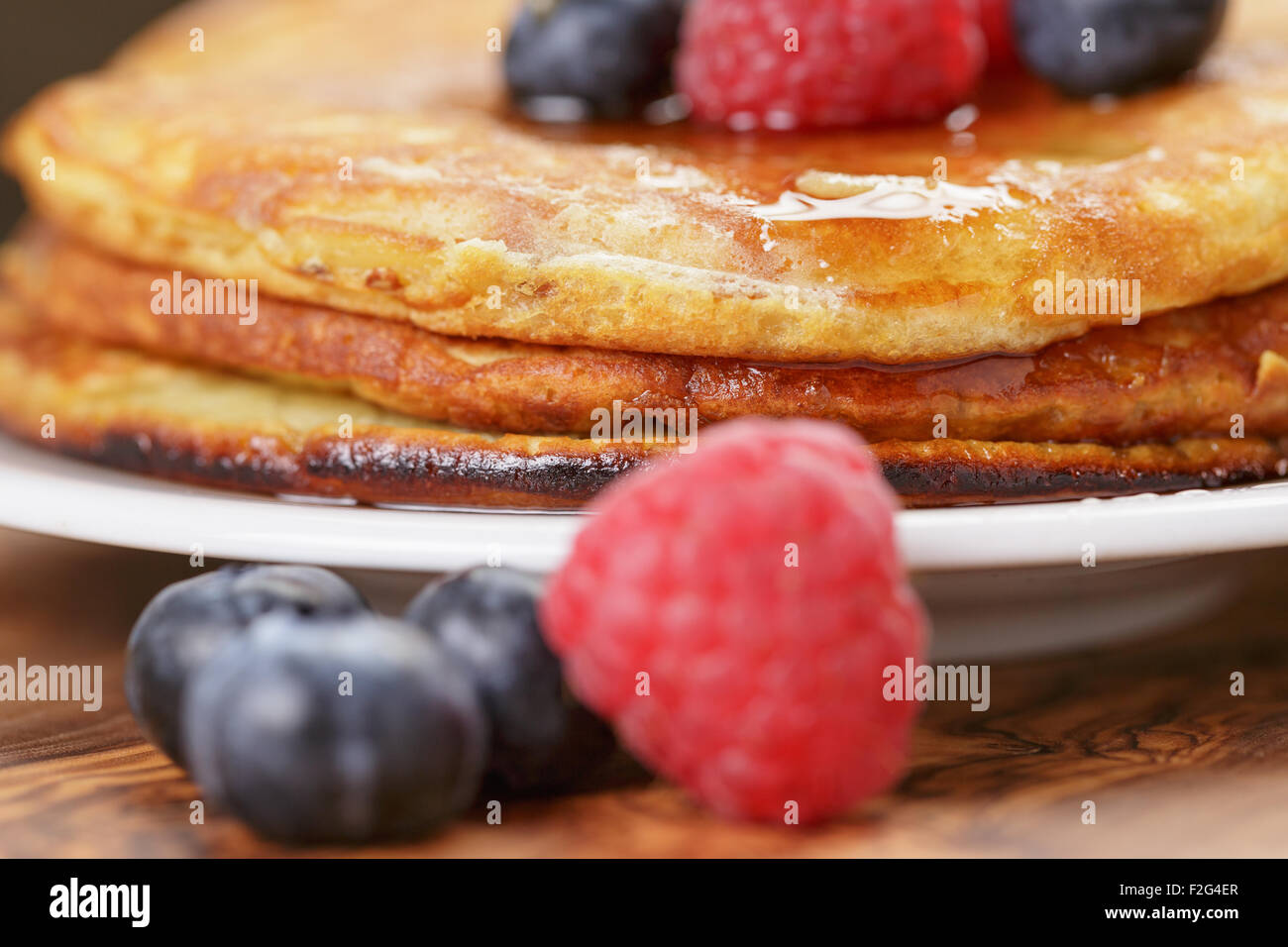 Pancakes with raspberry, blueberry and maple syrup Stock Photo - Alamy