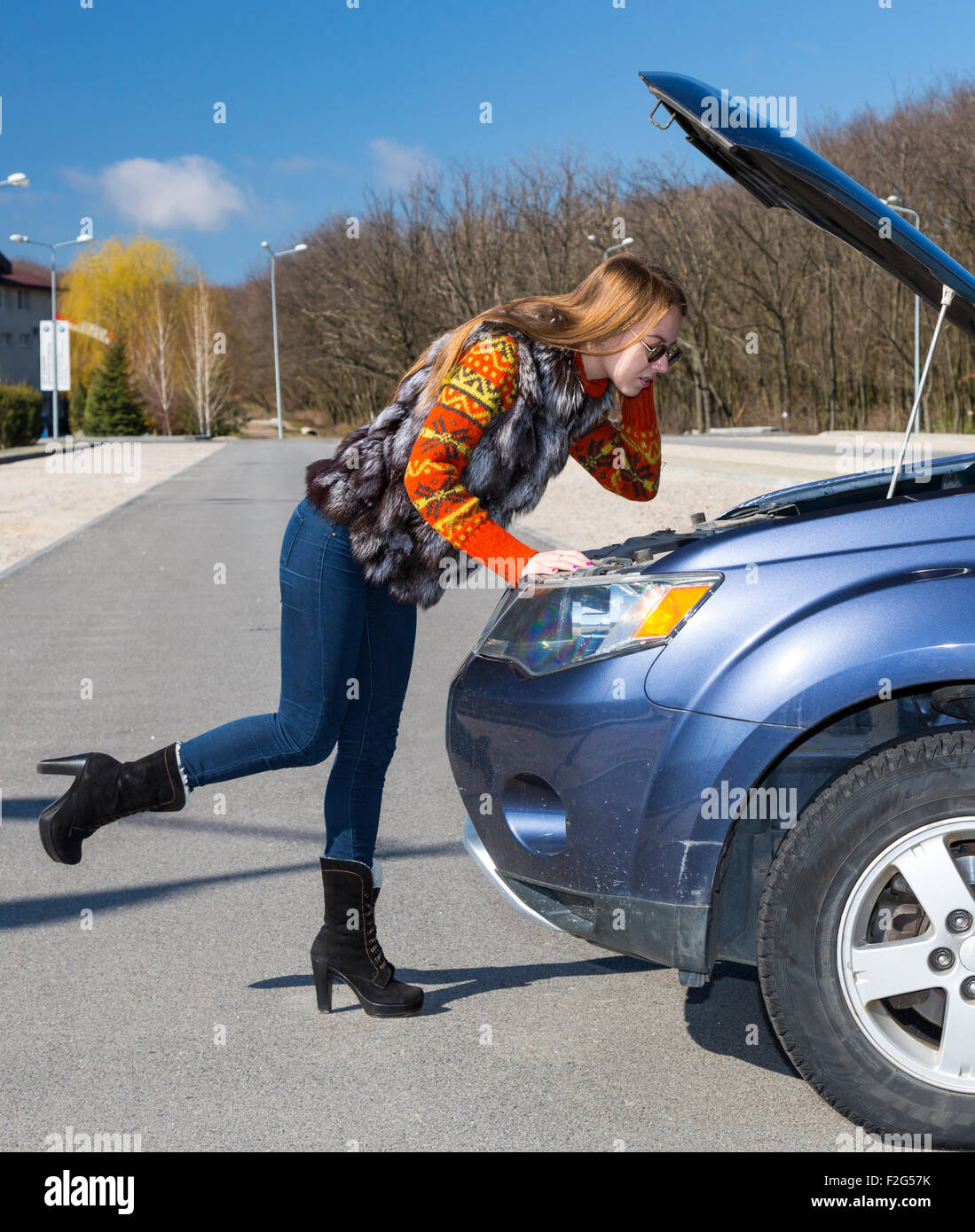 Female driver inspects her car engine Stock Photo - Alamy
