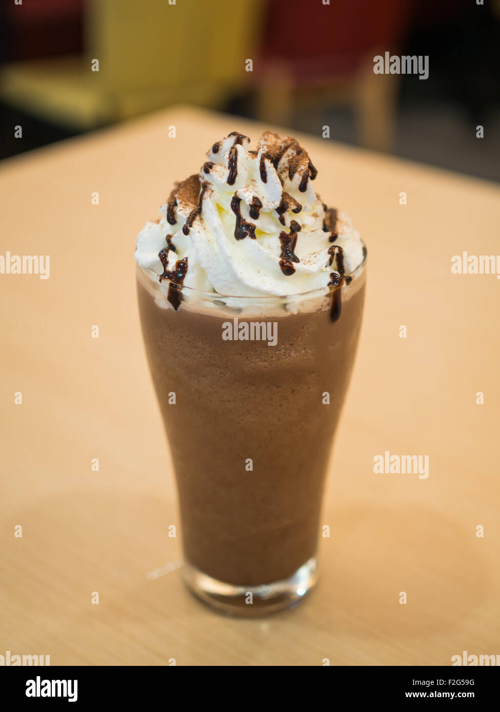 Delicious chocolate frappe with whipped cream on table Stock Photo - Alamy