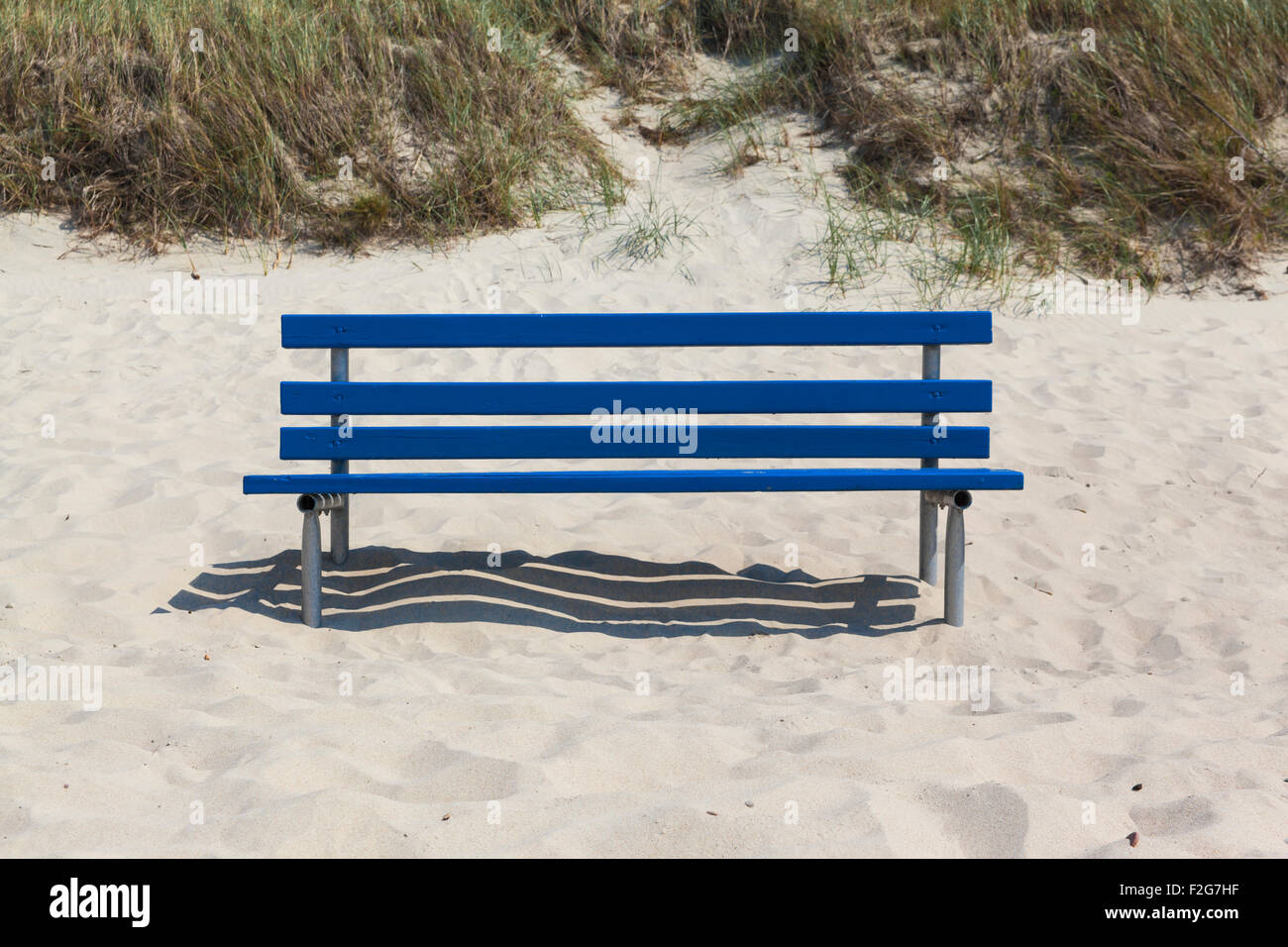 Blue bench in beach sand Stock Photo - Alamy