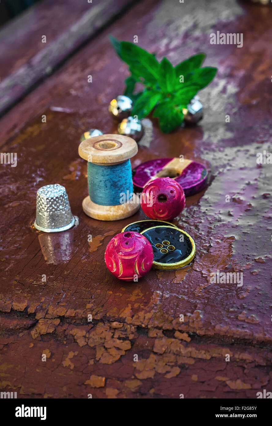 set of threads and buttons on old wooden background Stock Photo - Alamy