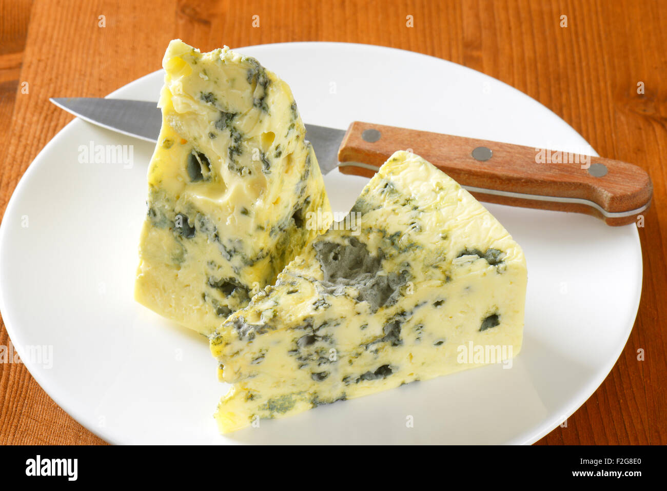 Two wedges of French blue cheese Stock Photo - Alamy