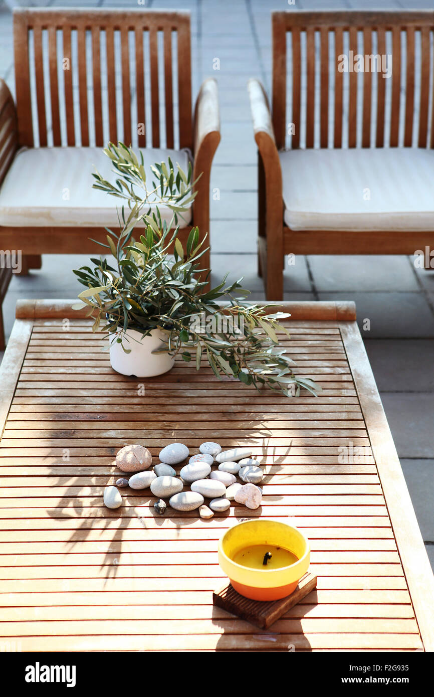 Seating area with two teak chairs and table Stock Photo - Alamy