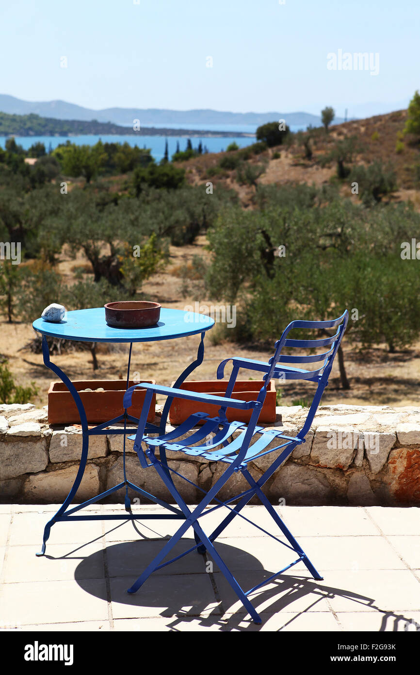 Greek style blue metal table and chair Stock Photo - Alamy