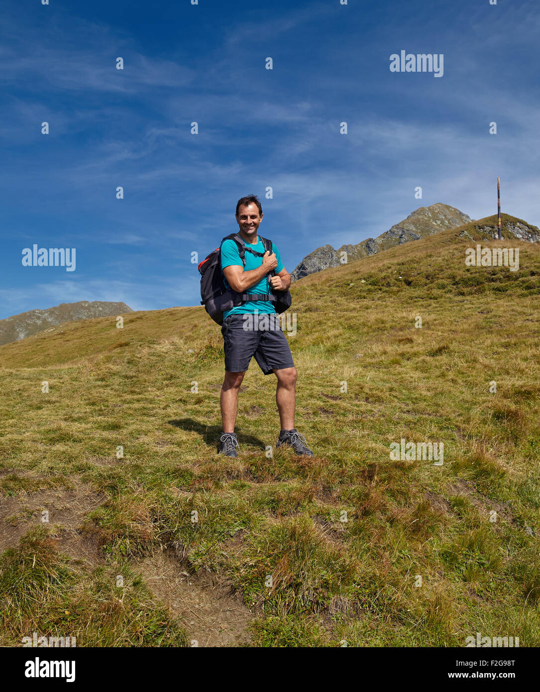 Full length portrait of a tourist with backpack on mountain Stock Photo ...