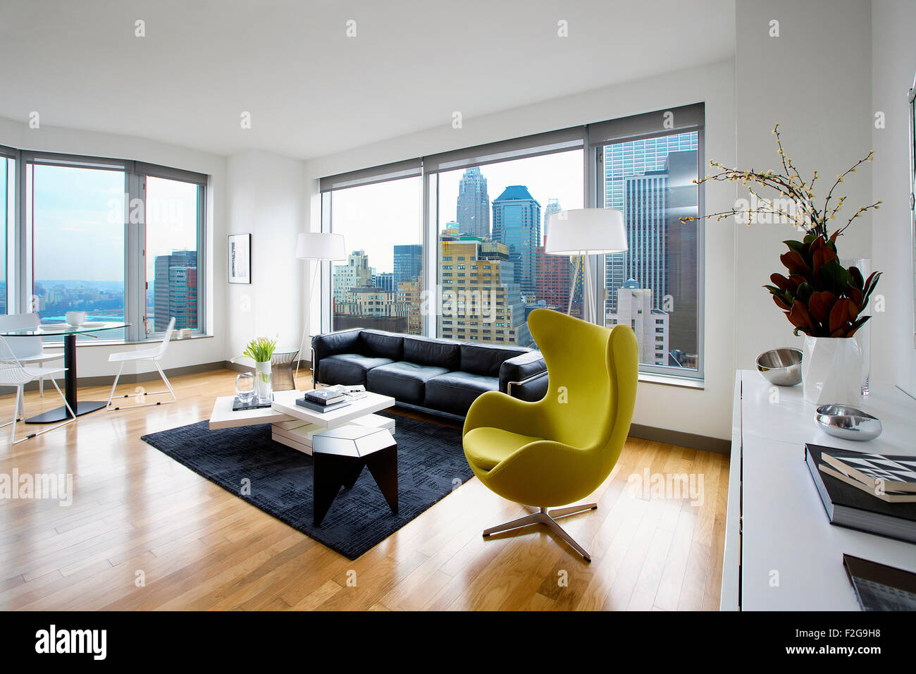 Modern living room with city view Stock Photo - Alamy