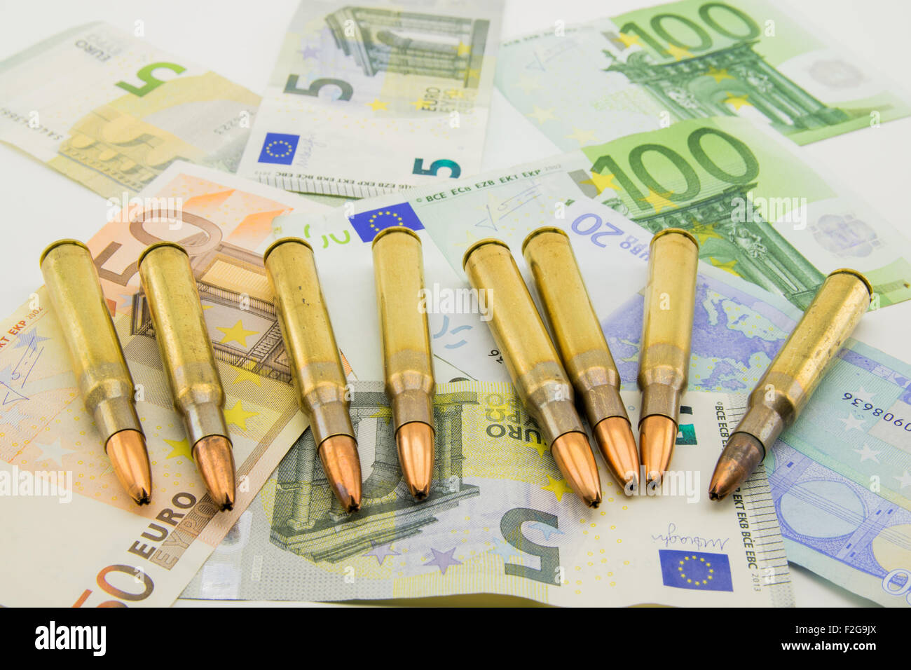 Composition with golden bullets and colorful banknotes Stock Photo - Alamy