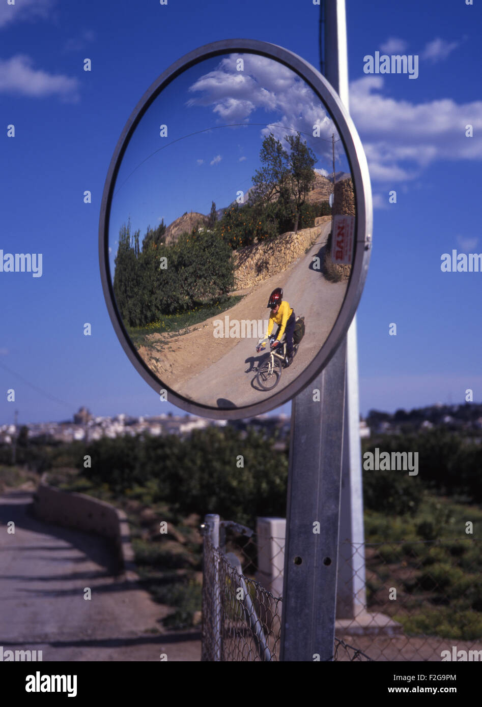 Cyclist in road junction mirror, near Altea, Alicante, Spain Stock ...