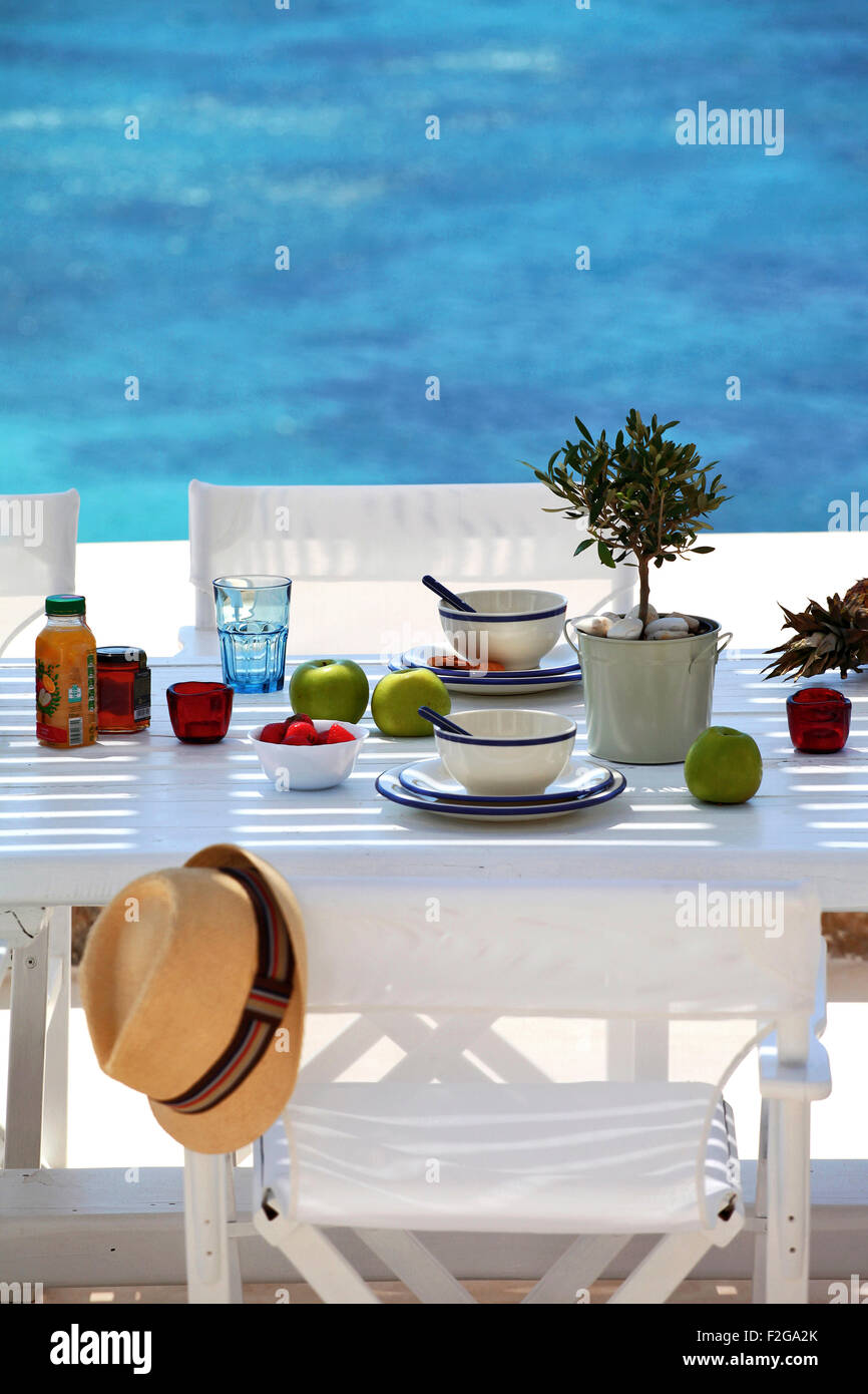 Outdoor dining table with sea backdrop Stock Photo - Alamy