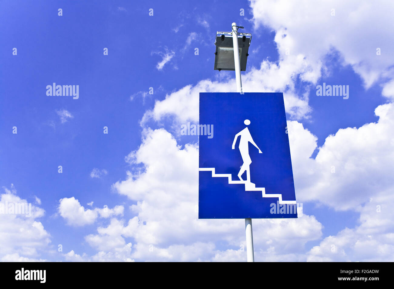 Information sign showing stairs over blue sky Stock Photo - Alamy