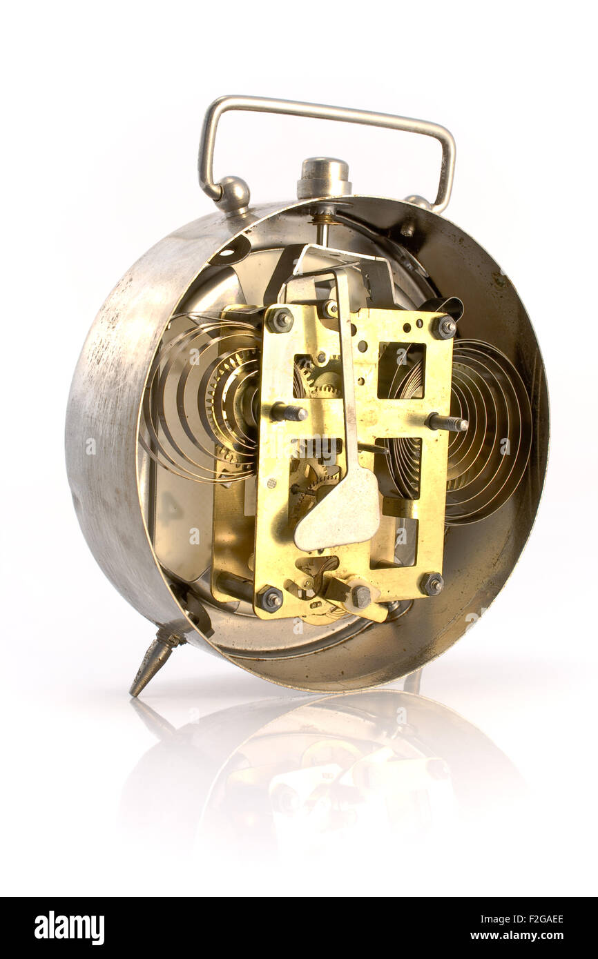 Inside mechanism of old alarm clock isolated on white Stock Photo - Alamy