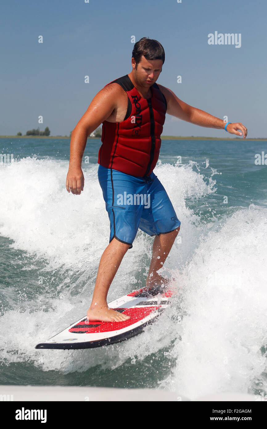 A man surfing on a boat wake Stock Photo - Alamy