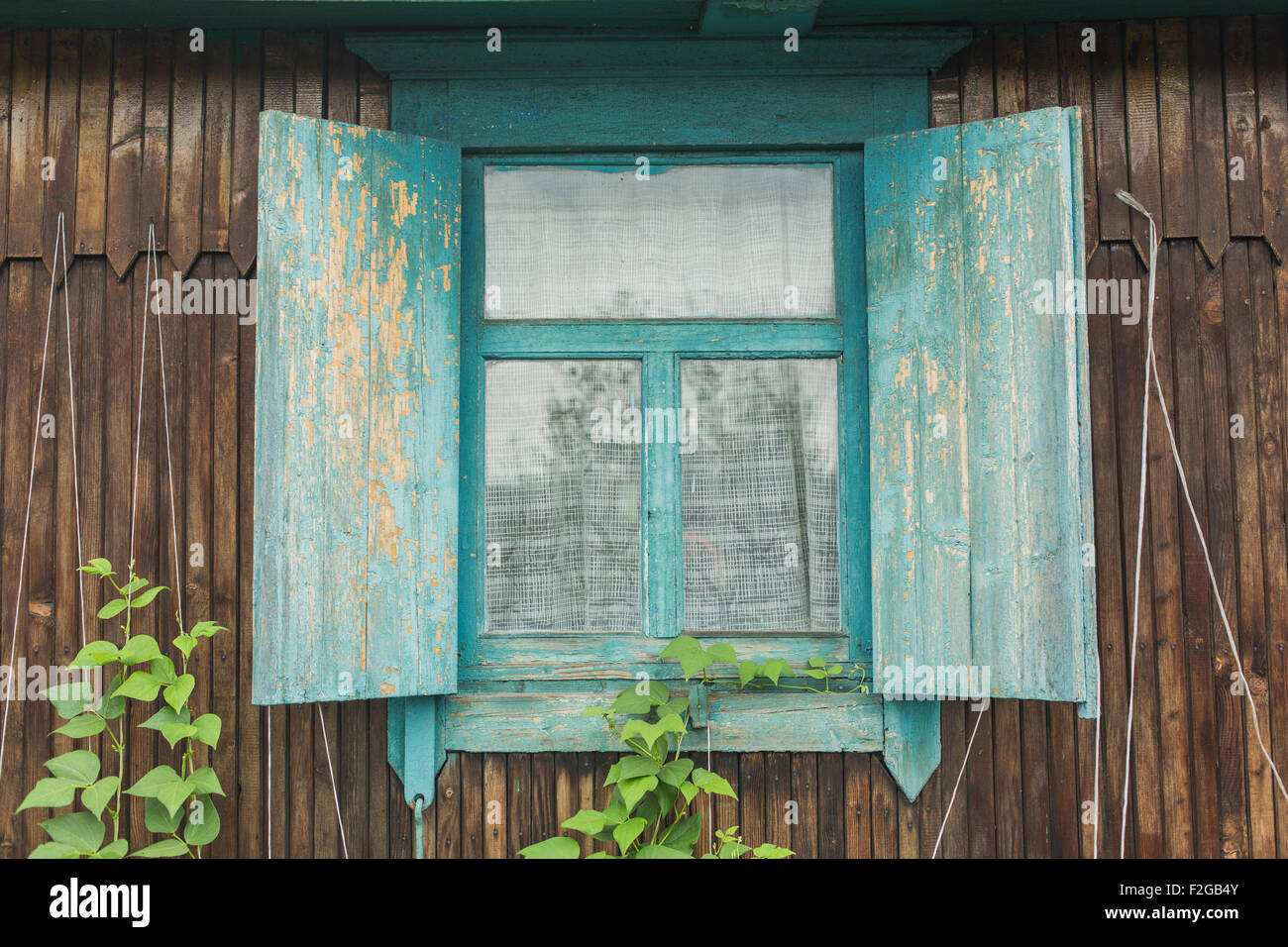 Old window of a wooden house wall Stock Photo - Alamy