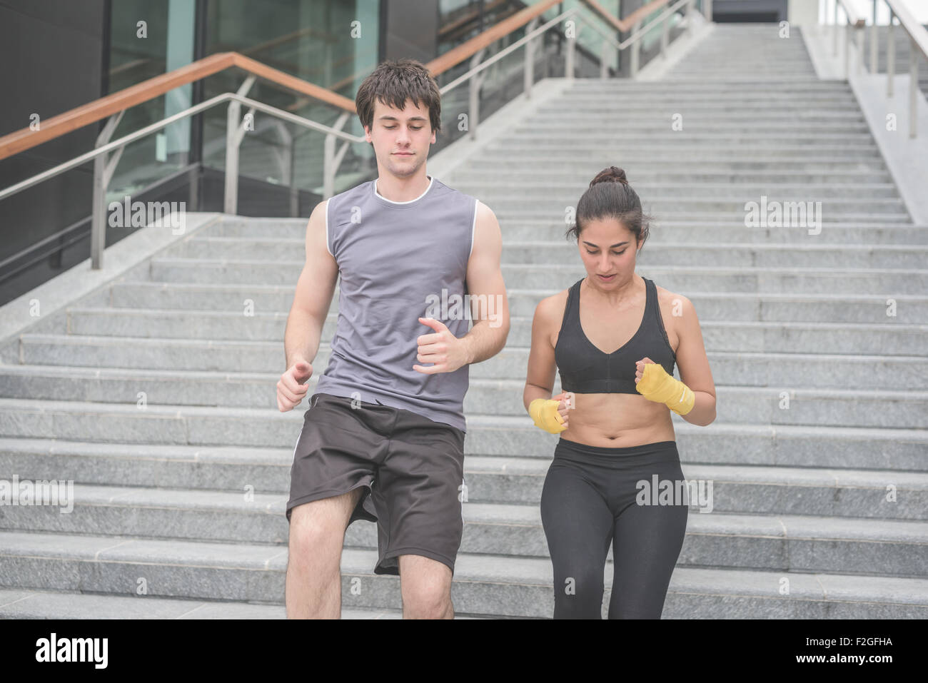 Young woman running downstairs hi-res stock photography and images - Alamy