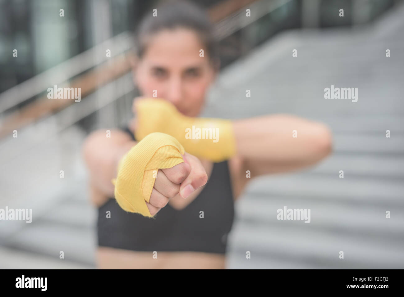 Half length of a young handsome caucasian brown hair boxer woman boxing ...