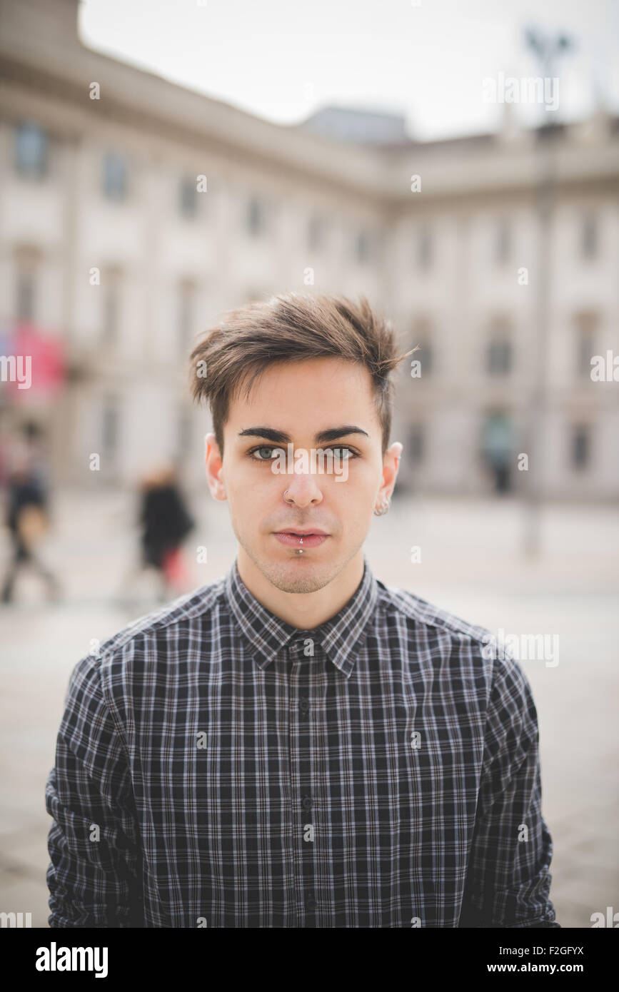 Half length of a young handsome alternative dark model man looking in ...