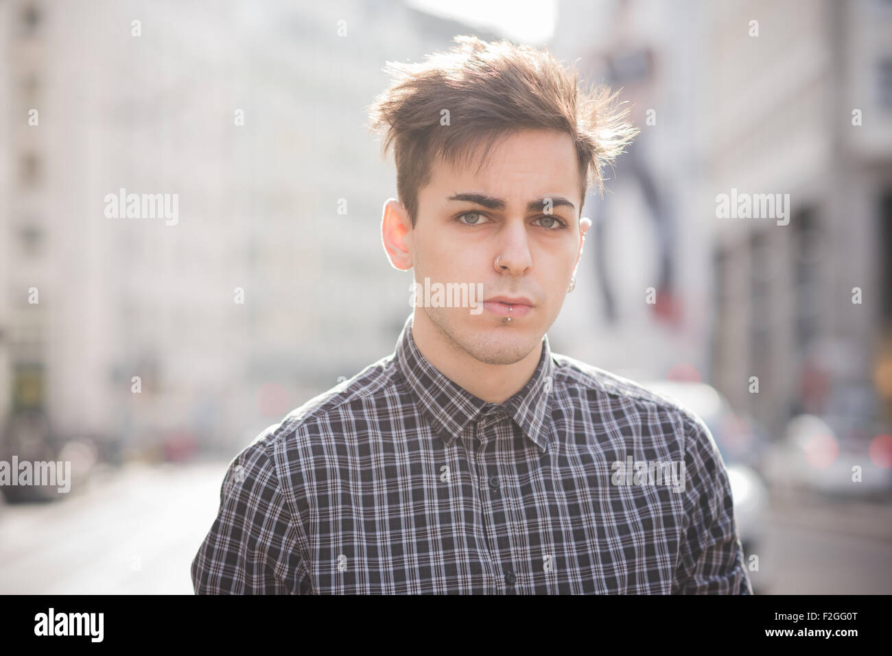 Portrait of young handsome alternative dark model man with central ...