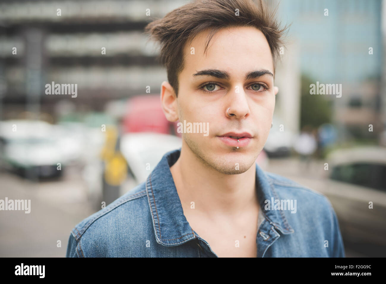 Portrait of a young handsome alternative dark model man looking in ...