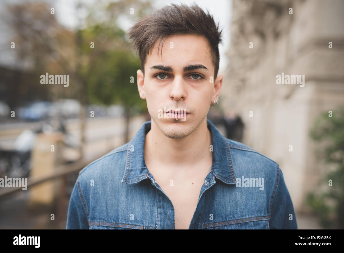 Portrait of a young handsome alternative dark model man looking in ...