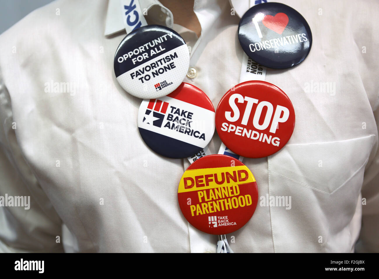 A conservative supporter wears a variety of issue buttons at the ...
