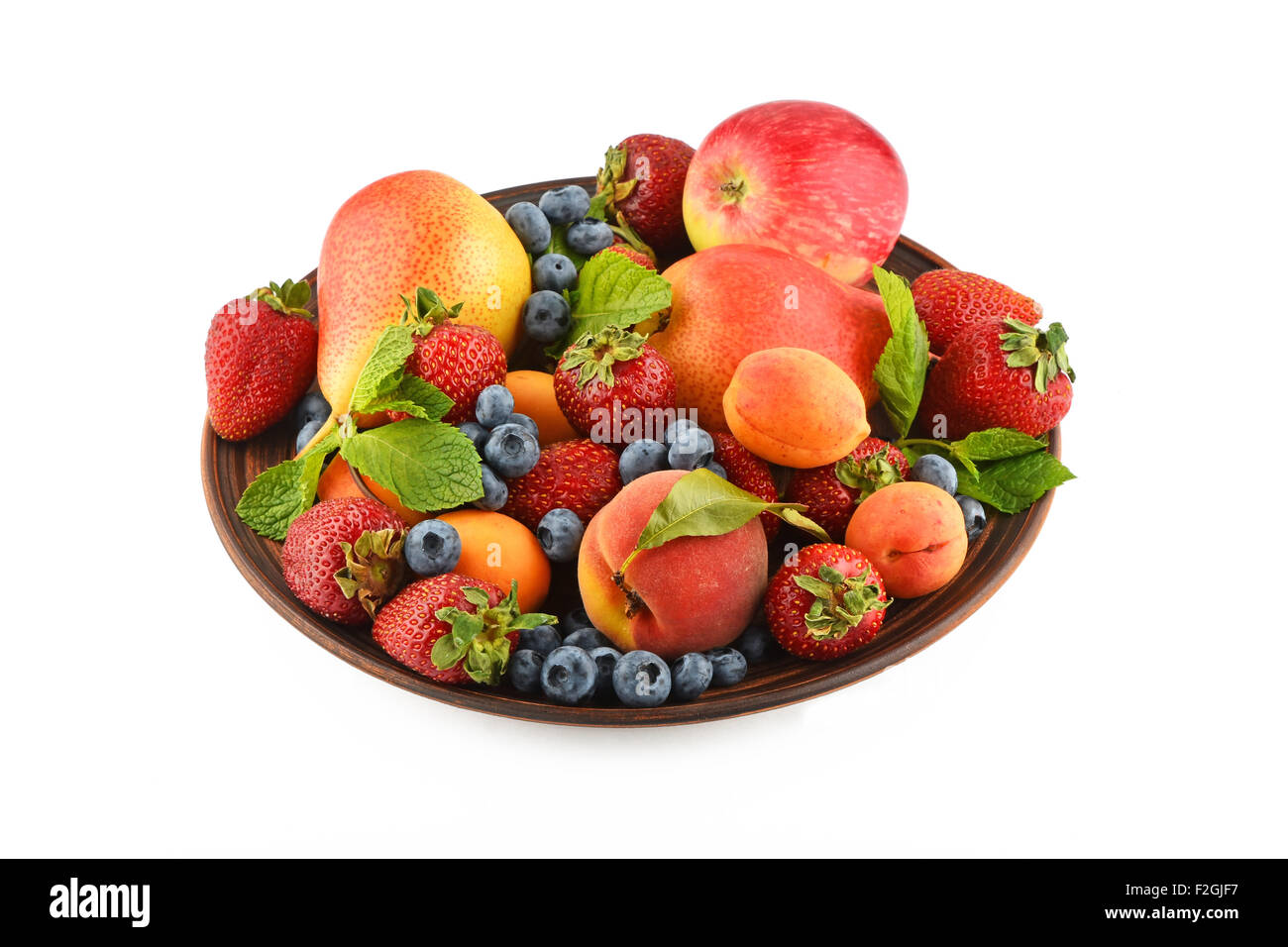 Mellow fresh summer fruits and berries mix with mint leaves in ceramic ...