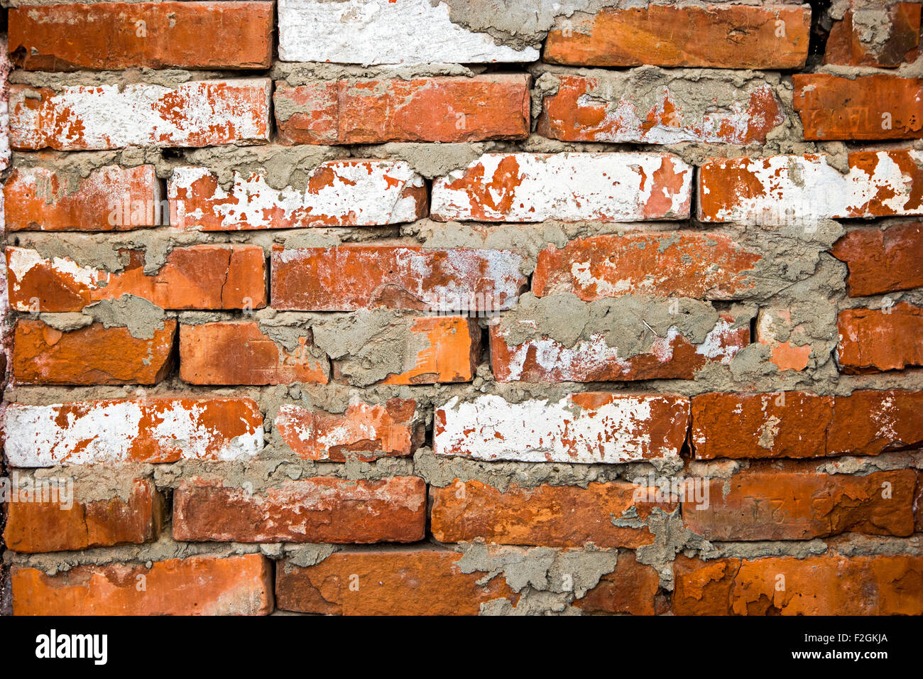 Red brick wall closeup with sparse white bricks, old obsolete texture ...