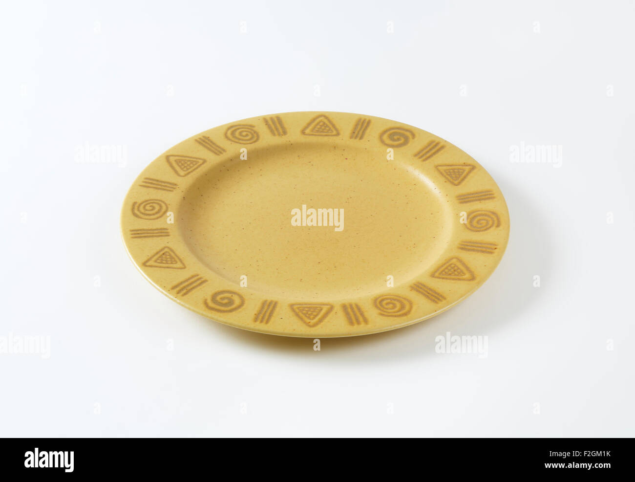 Rustic ceramic plate decorated with symbols on the rim Stock Photo - Alamy
